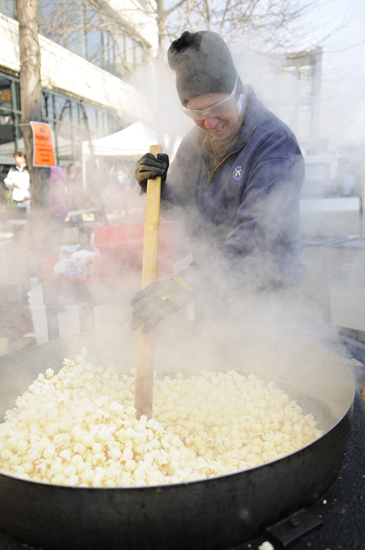 Nancy Strack, co-owner of LongHouse Farm, stirs kettle corn as it pops ...